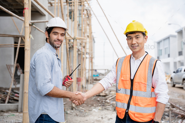 The engineer manager and foreman construction workers shake hands on ...