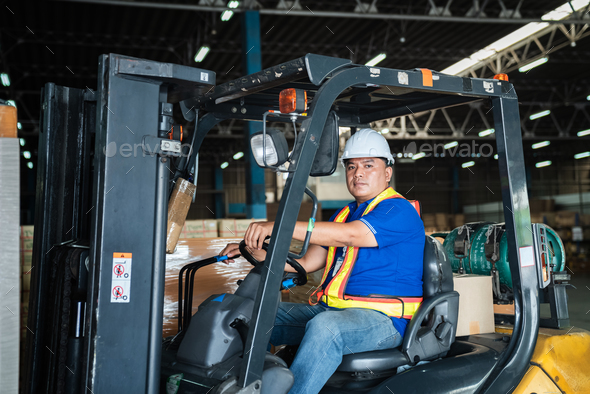 Warehouse worker workers with forklift in a warehouse. Use forklift ...