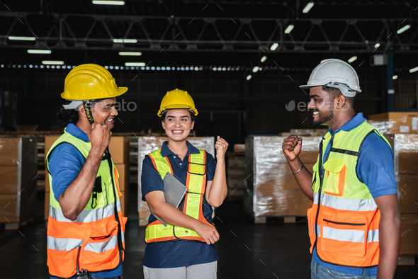 Group warehouse workers shake hands to celebrate and be happy in the ...