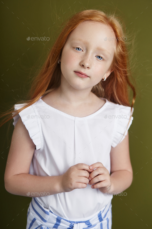 Beautiful red-haired girl with long hair and beautiful big blue eyes ...