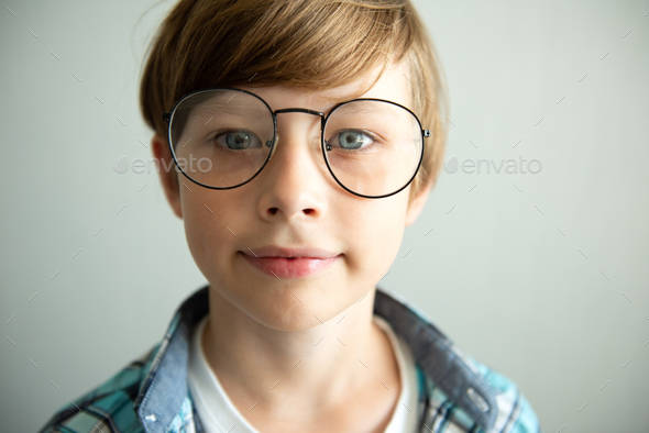 Teenager kid boy in myopia correction glasses Stock Photo by irinapavlova1