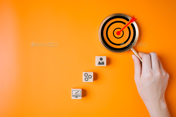 Magnifying glass with business target goal icons for increasing Stock ...