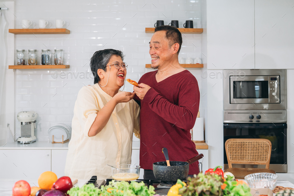 Happy Vacation Time: Elderly Couple Cooking Together in the Kitchen ...