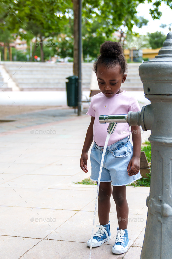 Grieving Little African Girl: Colorful Park Fountain Leaks, Trees ...