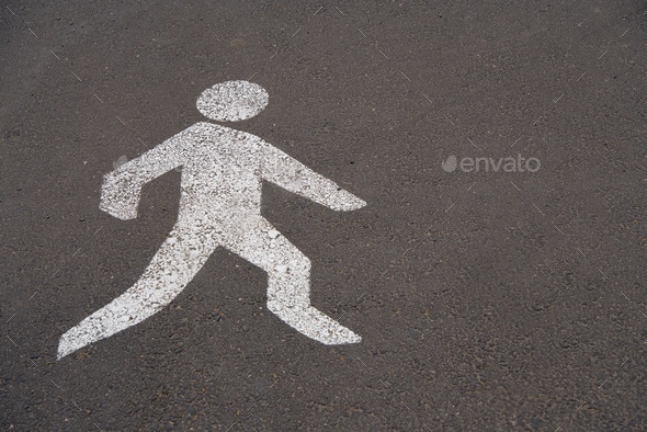 Traffic Education. Pedestrian symbol drawn in white on the roadway ...