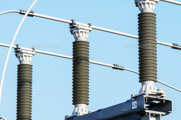 View of high voltage insulators on a clear blue sky Stock Photo by ...