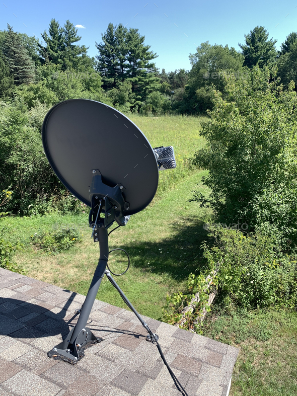 Vertical shot of a satellite in a park surrounded by green trees Stock ...