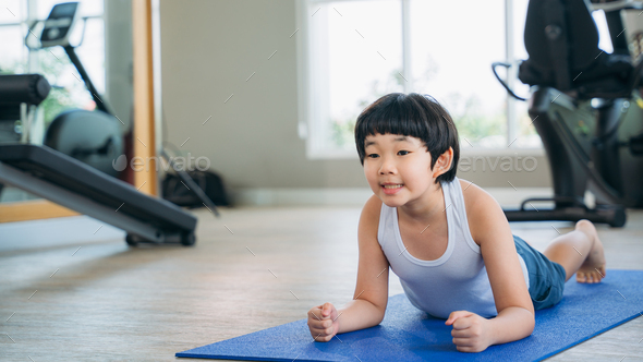 Child doing plank exercise in fitness. Enhancing Fitness and Wellness ...
