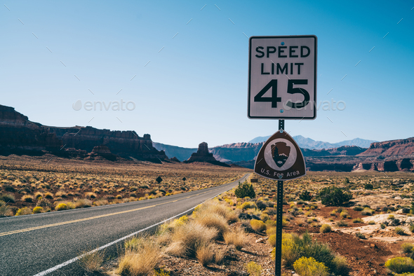 Empty road with speed limit sign on roadside Stock Photo by GaudiLab