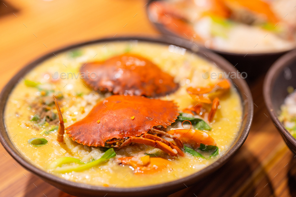 Seafood congee bowl with crab in restaurant Stock Photo by leungchopan