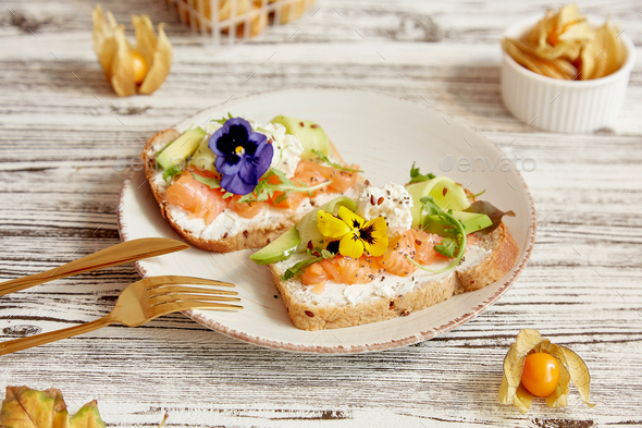Aesthetic appetizer toasts with smoked salmon, arugula, avocado ...