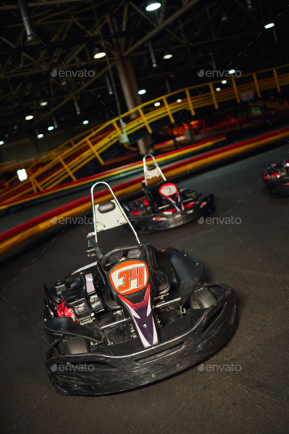 modern racing cars inside of indoor circuit, motor race vehicles, go ...