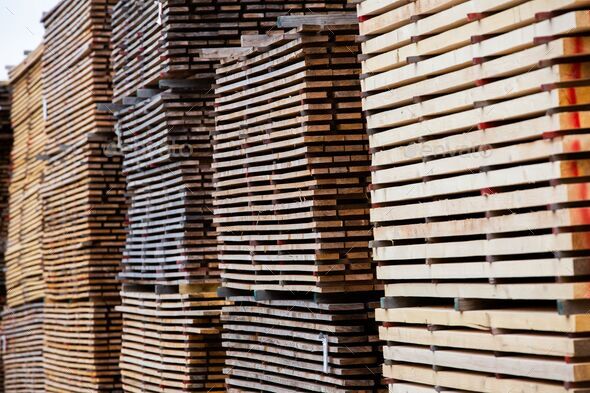 Stacked wooden planks in a warehouse. Carpentry material. Stock Photo ...