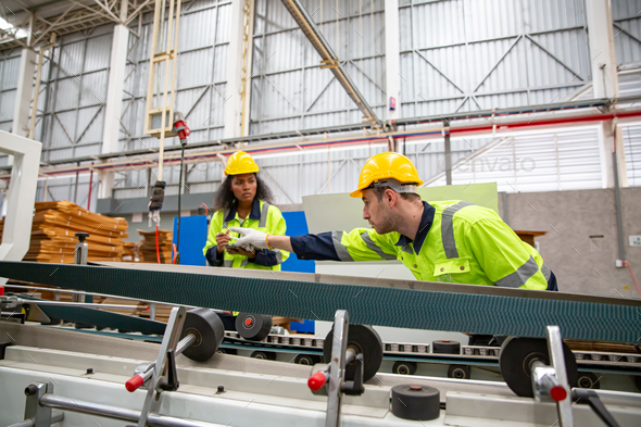 Industrial factory workers working in metal manufacturing industry ...