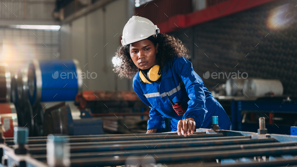 Portrait of industrial worker inspecting and check up machine at ...