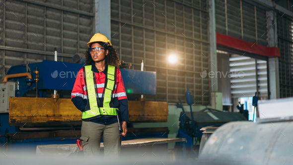 Industrial worker inspecting and check up machine at factory machines ...