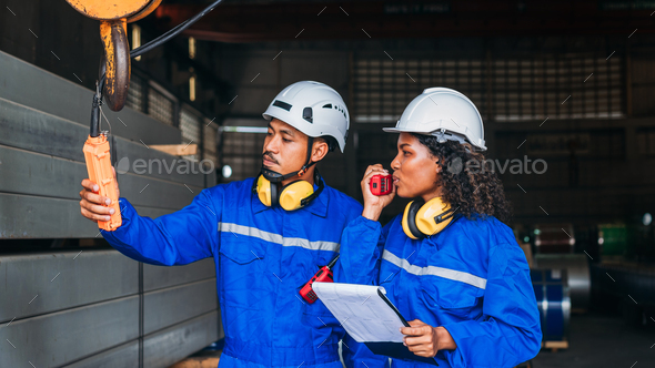 Industrial worker inspecting and check up machine at factory machines ...