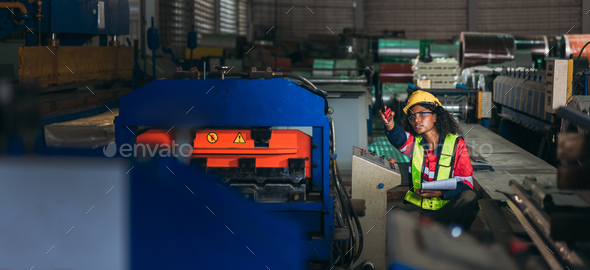 Industrial worker inspecting and check up machine at factory machines ...