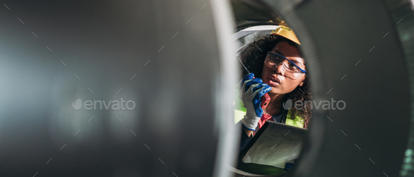 Industrial worker inspecting and check up machine at factory machines ...