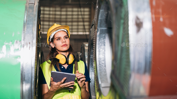 Industrial worker inspecting and check up machine at factory machines ...