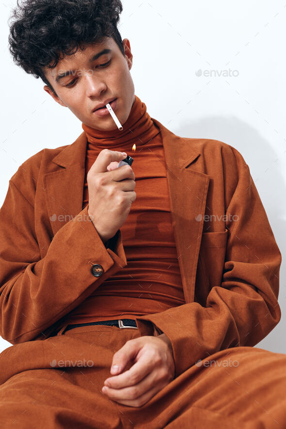 Man fashion student standing thoughtful portrait cigarette beige ...