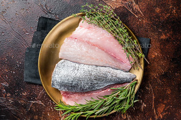 Fresh Raw Gilthead Sea bream fish fillets ready for cooking. Dark ...