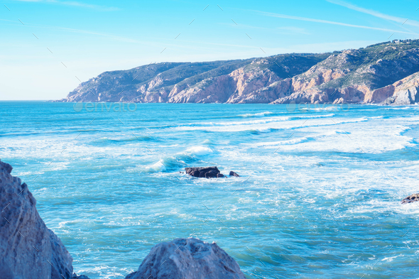 blue lagoon, rocky ravine seashore foamy sea waves surrounded by ...