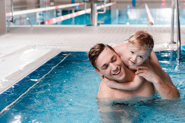 happy toddler kid hugging swim coach in swimming pool Stock Photo by ...