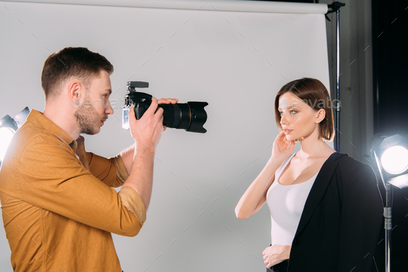 Handsome photographer working with beautiful young model in photo ...