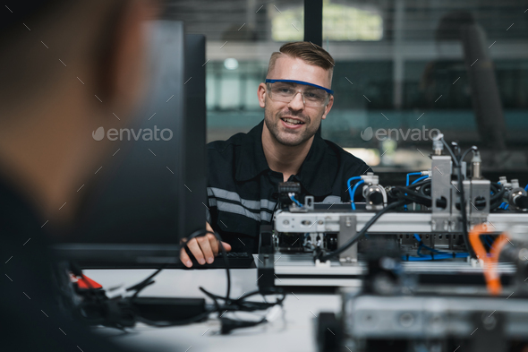 Student engineer Assembling Robotic Arm with computer in Technology ...