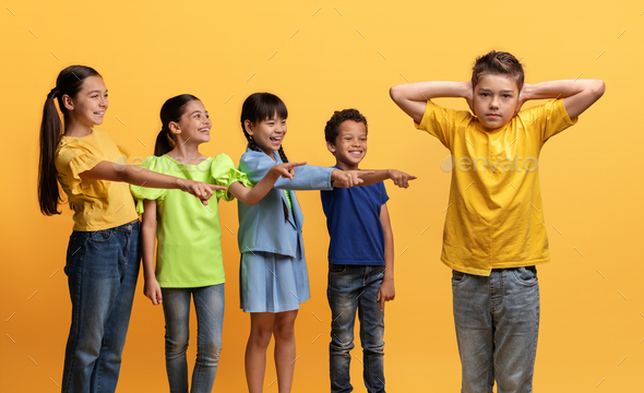 Angry cruel teenagers laughing at their classmate, yellow background ...
