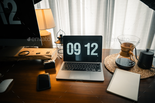 Home computer desk and digital clock on screen Stock Photo by ArtRachen