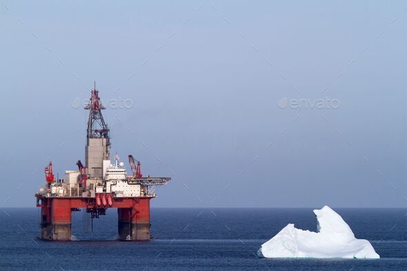 Offshore oil rig on the surface of blue water in the ocean with a ...