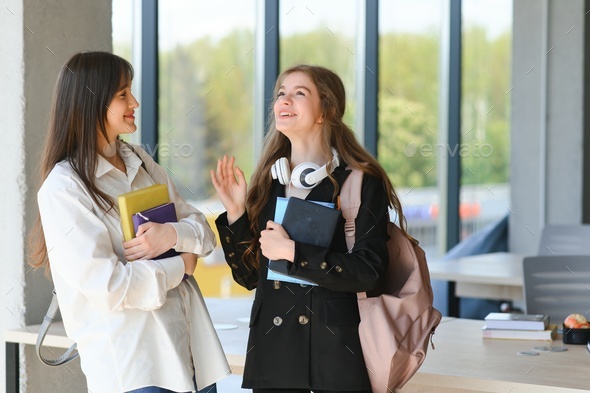 Education. Two clever modern students in black and white uniform study ...