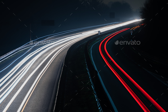 Abstract image of night traffic lights on the road. Car light trails at ...