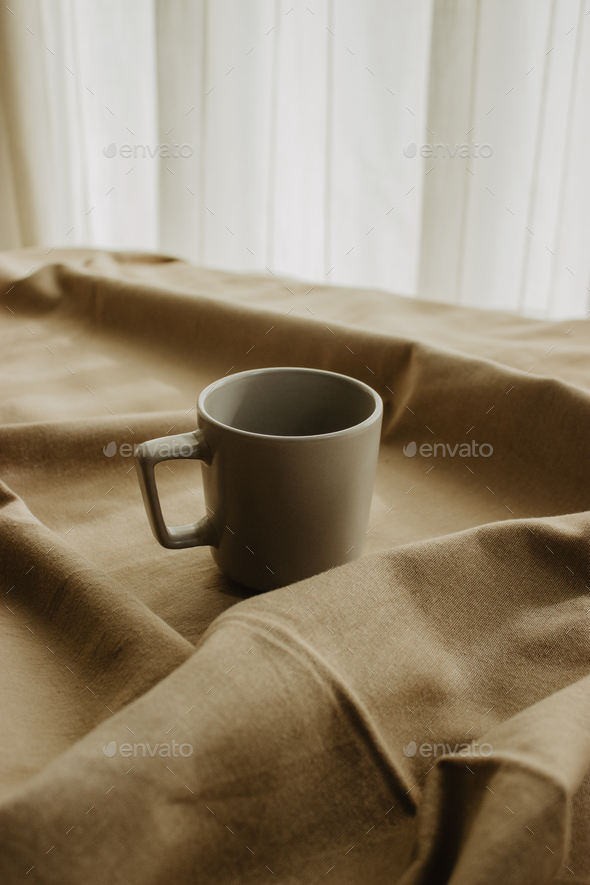 Empty grey coffee cup on a beige isolated background. Concept coffee ...