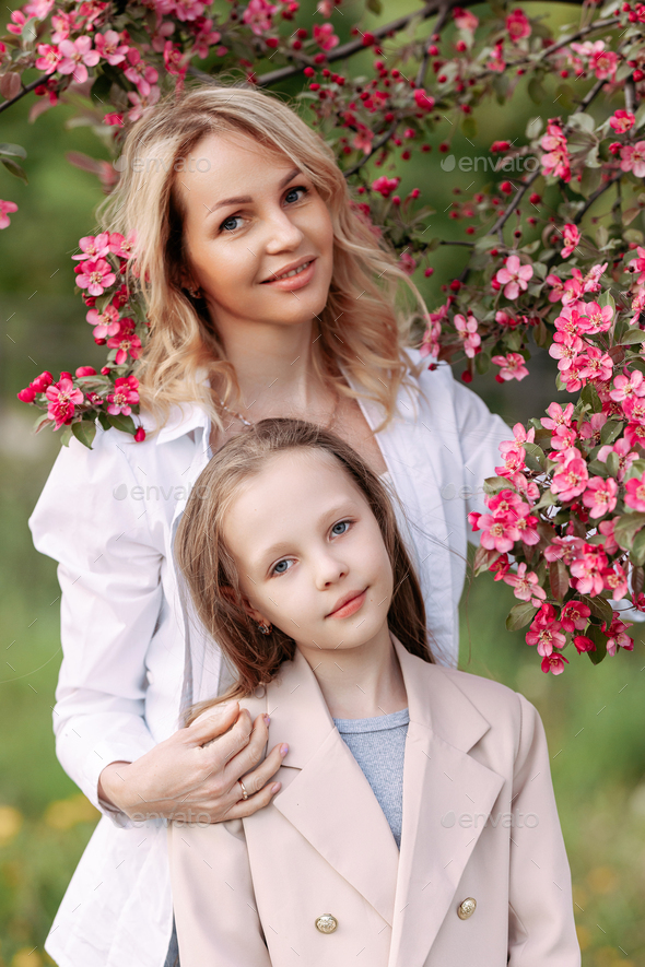 Mother and Daughter Among Cherry Blossoms Stock Photo by kaplickaya