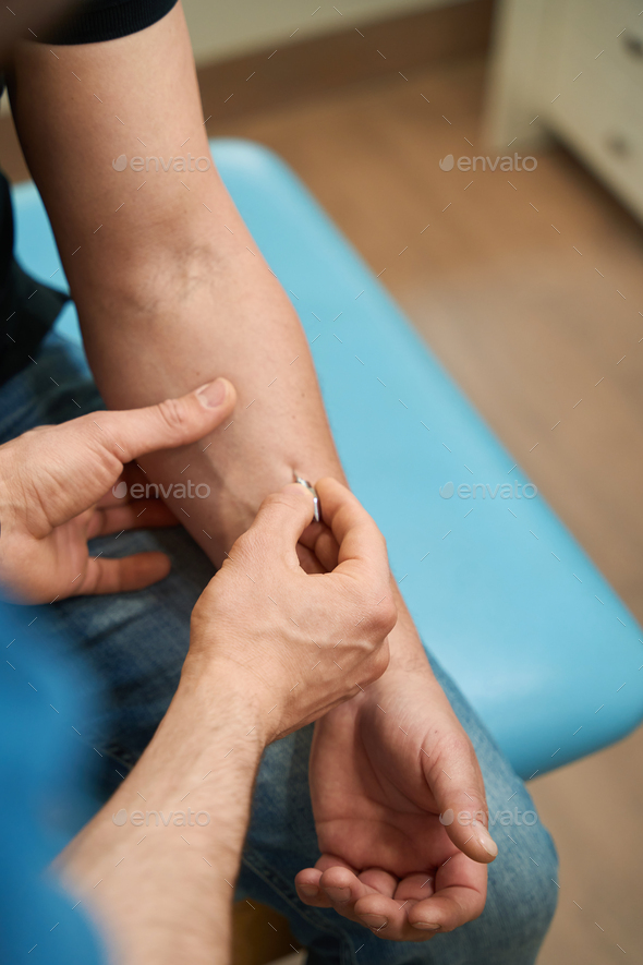 Neurologist assessing patient sensory function during pinprick test ...