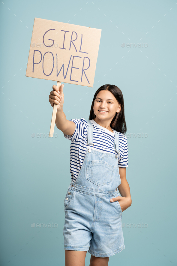 Positive energetic teen girl hold girl power placard, empowerment sign ...