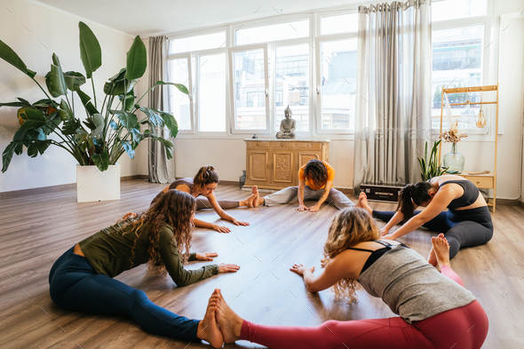 Yoga class stretching sitting in a circle shape Stock Photo by guillemd
