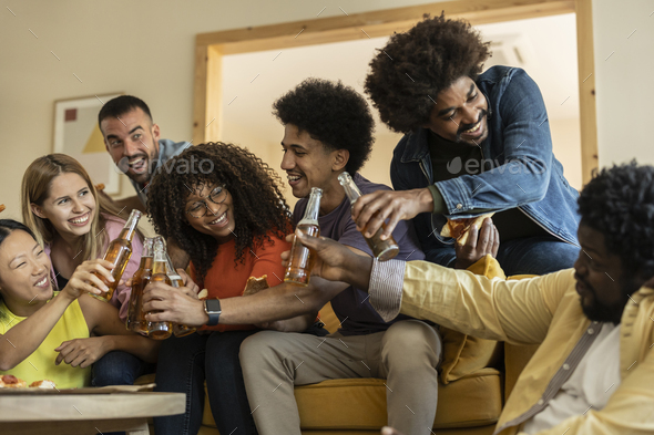 group multiracial people drinking beers at home party - diverse young ...