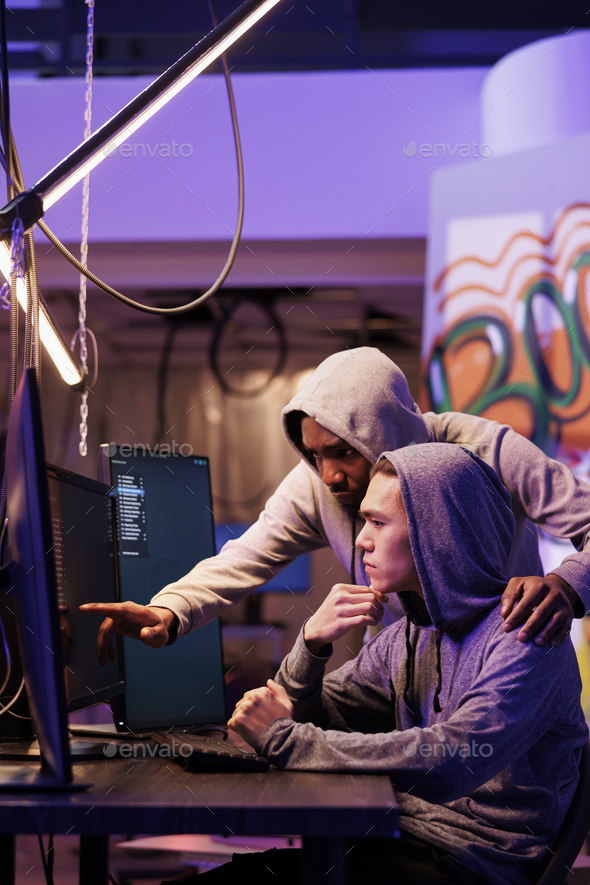 Confused hacker pointing at code mistake Stock Photo by DC_Studio ...