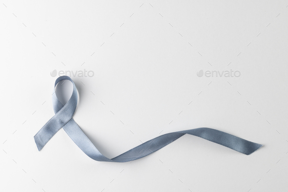 Composition of grey ribbon for cancer awareness, on white background ...