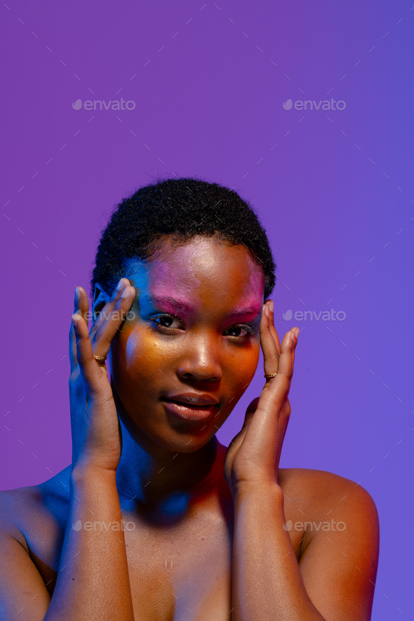 African American Woman With Short Hair And Colourful Make Up Touching