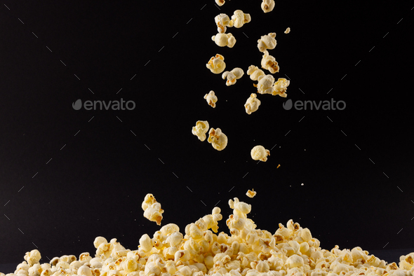 Image of pop corn spilled on black background Stock Photo by Wavebreakmedia