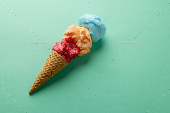 Horizontal image of three coloured flavours of ice cream in cone, on ...
