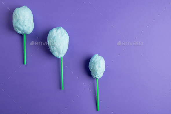 Horizontal image of homemade blue candy floss on three sticks, on ...