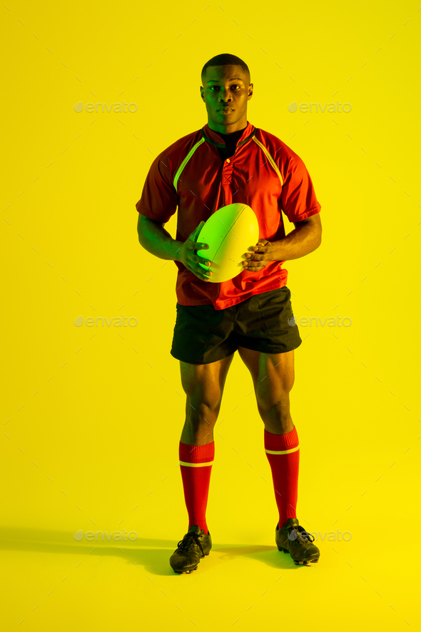 Portrait of african american male rugby player with rugby ball over ...