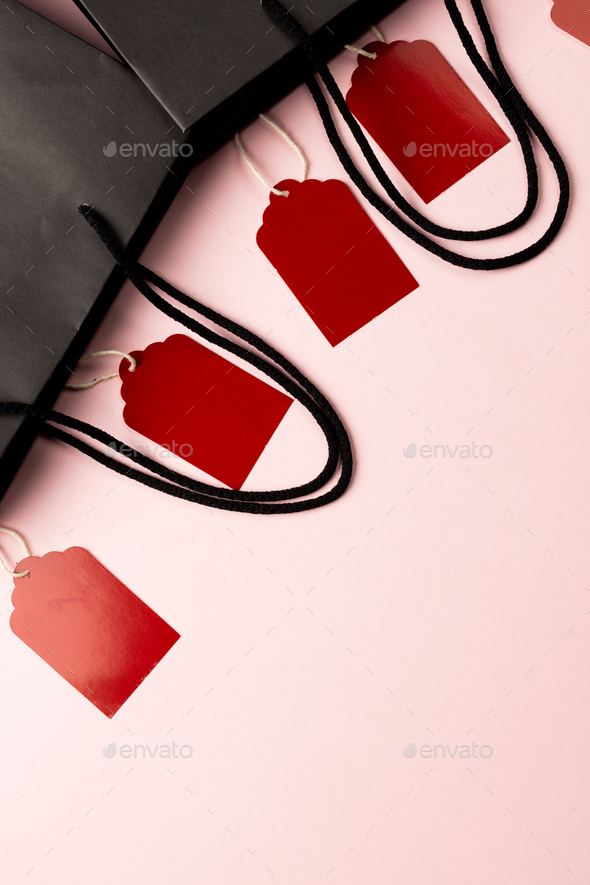 Composition of gift tags and bags with copy space on white background ...