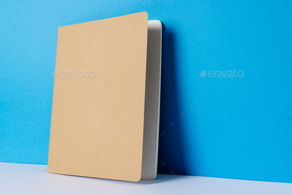 Close up of beige notebook with copy space on blue background Stock ...